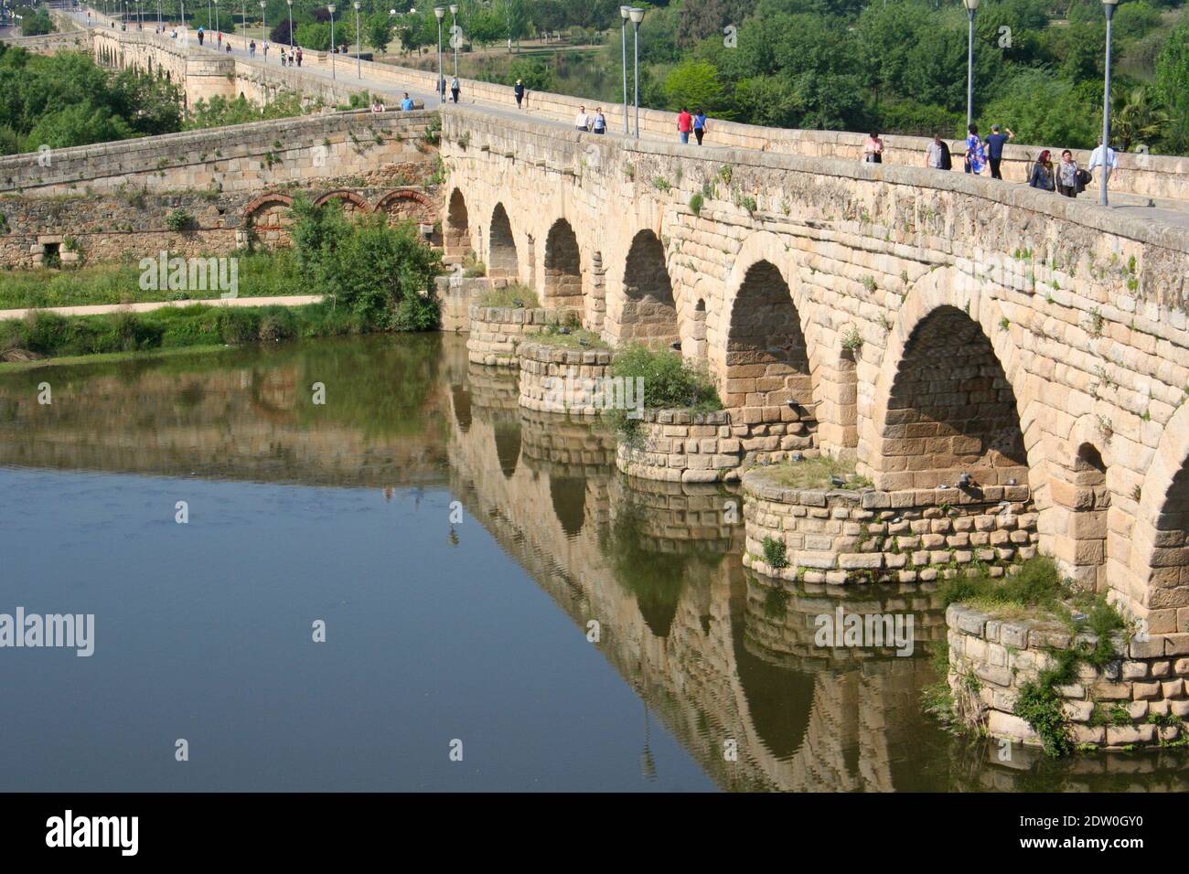 Long pedestrianised Roman stone bridge over the River Guadiana in ...