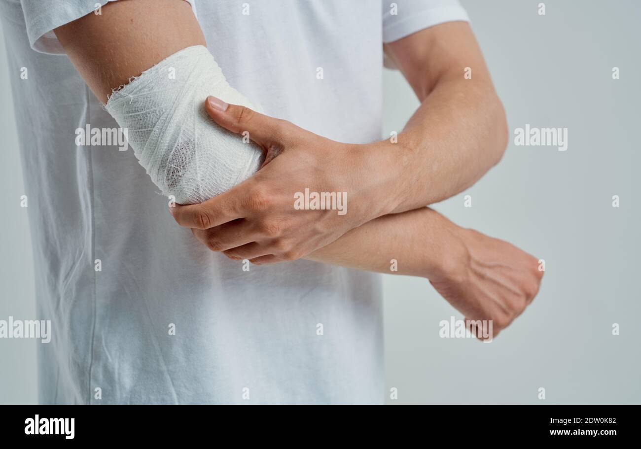 man with bandaged arm elbow and finger injury medicine Stock Photo - Alamy