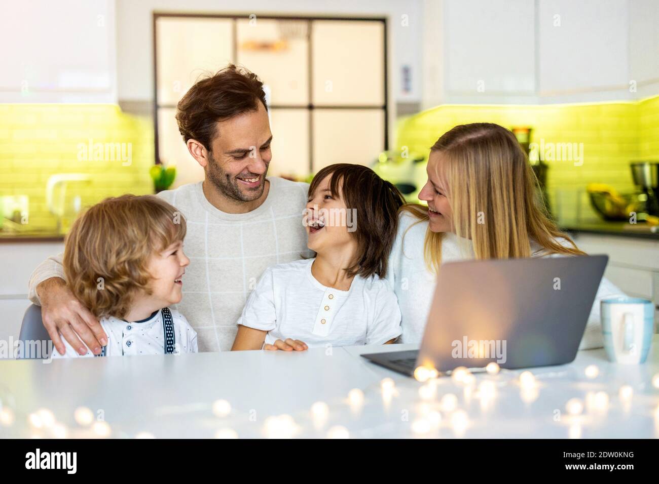 Happy young family using laptop at home Stock Photo - Alamy