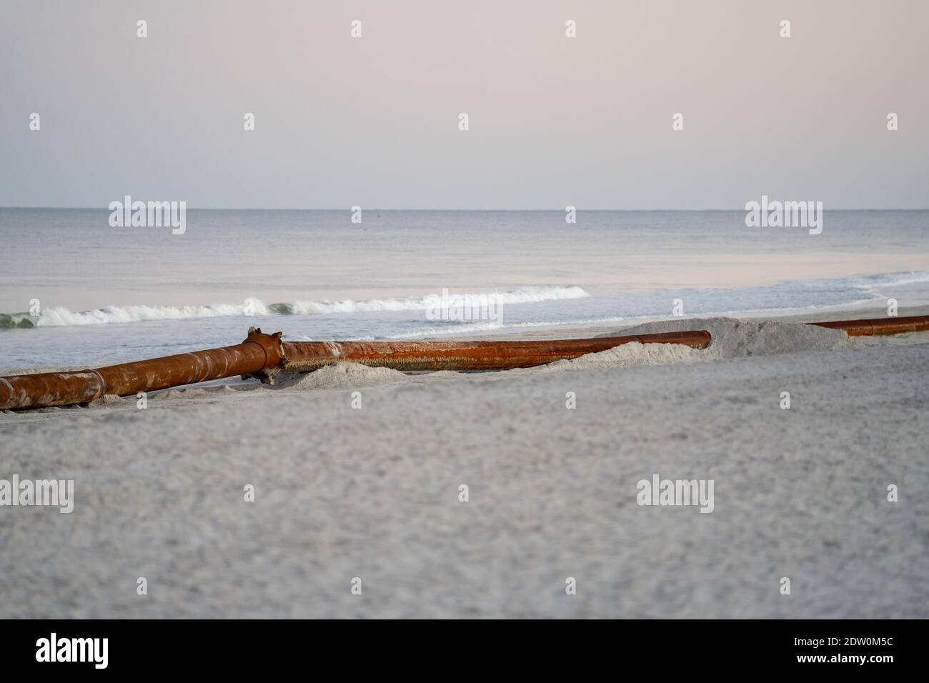 Pipes laying on the beach restoration project coastal USA Stock Photo ...