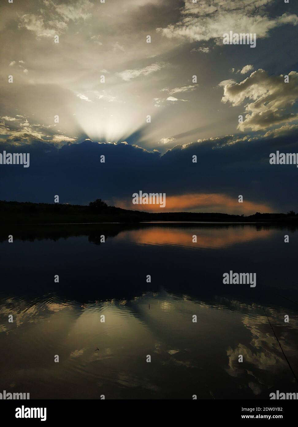 Natural landscape. Sunset over water, reflection of the sun and clouds ...