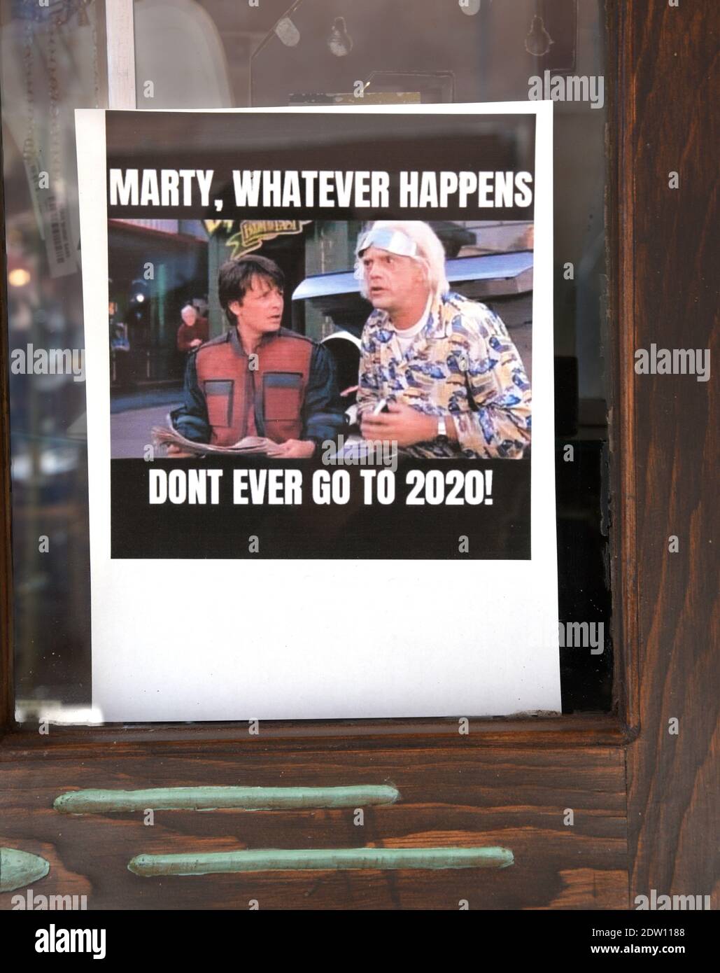 A humorous sign taped on a shop window in New Mexico references the ...