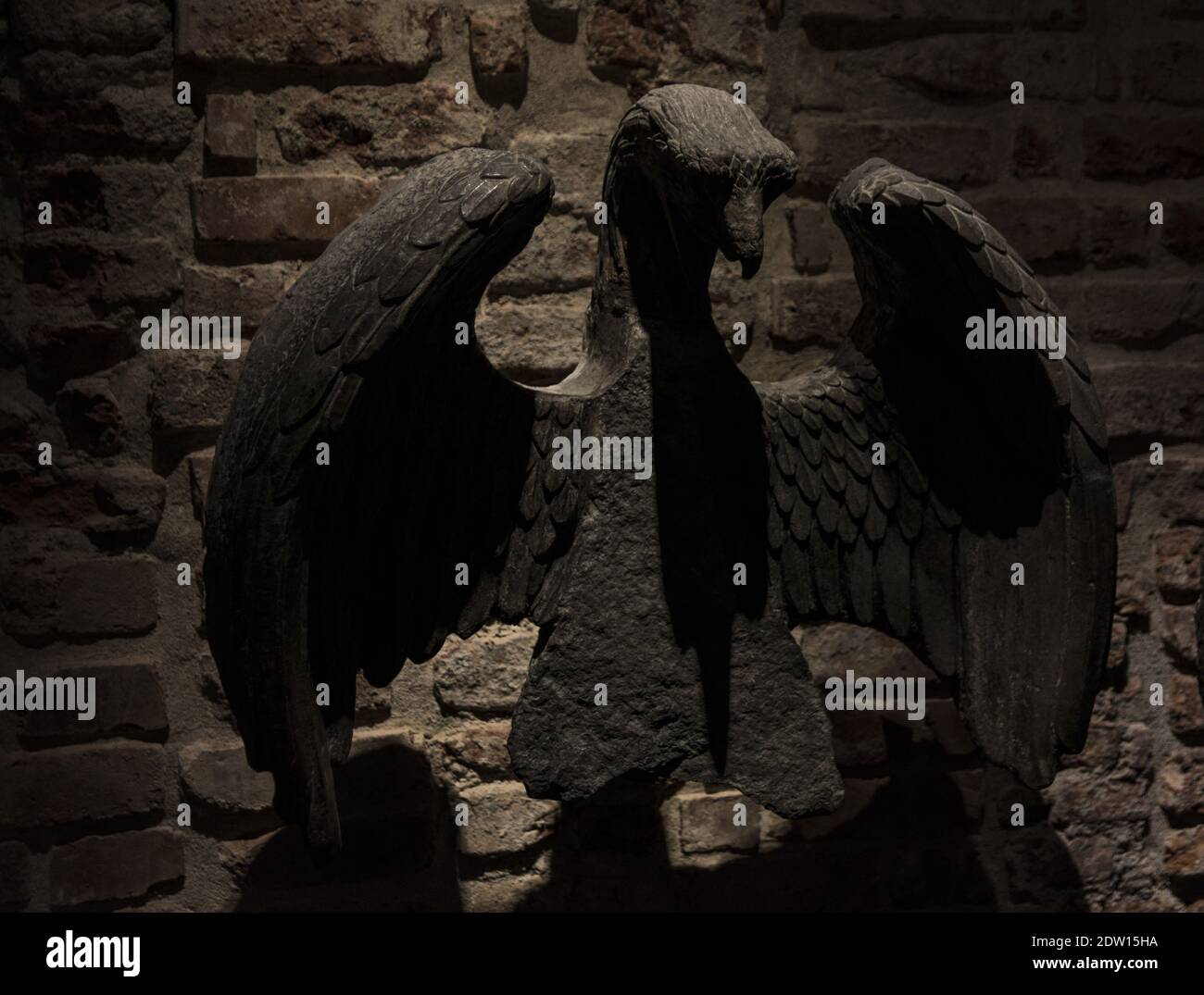 An eagle sculpted in stone, a historical museum piece with exposed ...