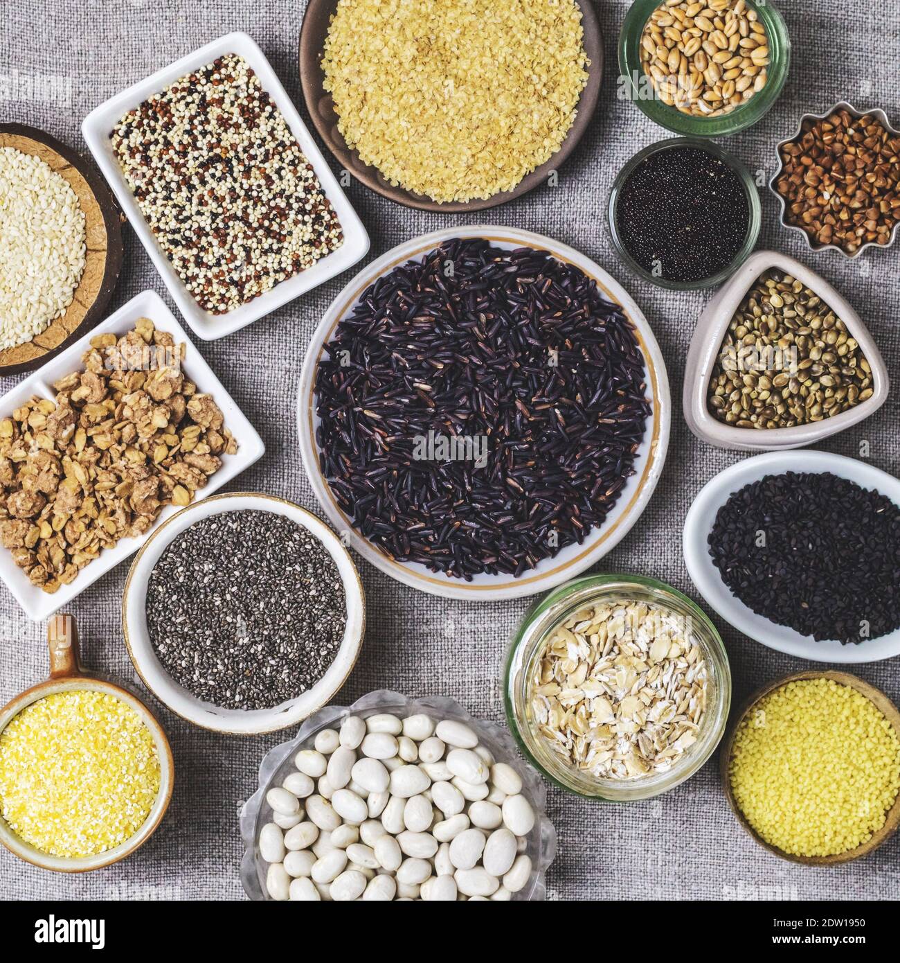 Food background of various cereals and grains in plates on a canvas ...
