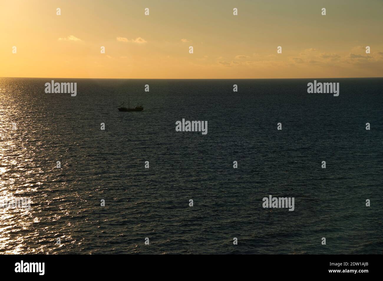 Sailing ship at sea at sunset Stock Photo - Alamy