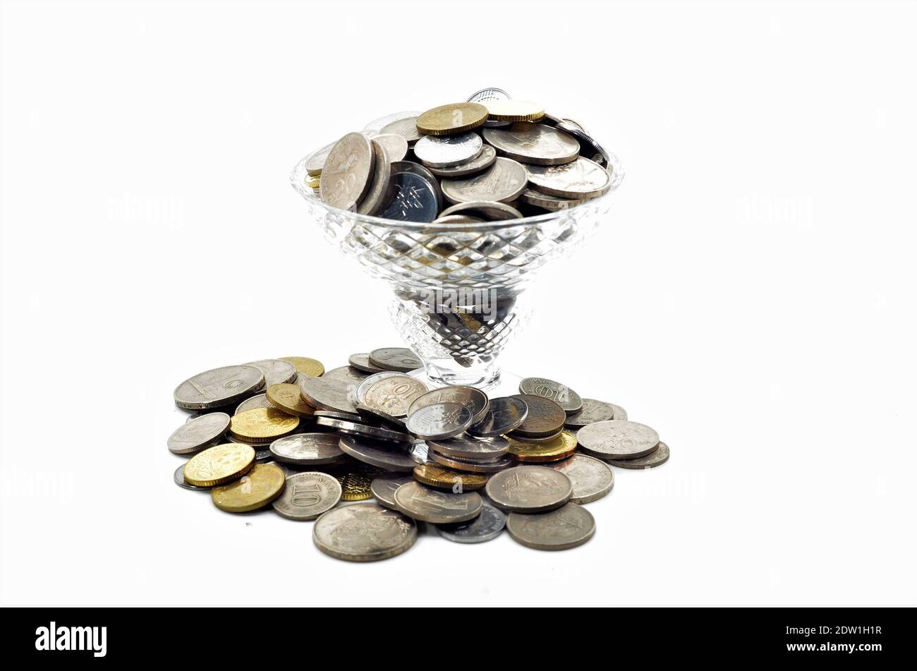 Coins In Glass On White Background Stock Photo - Alamy