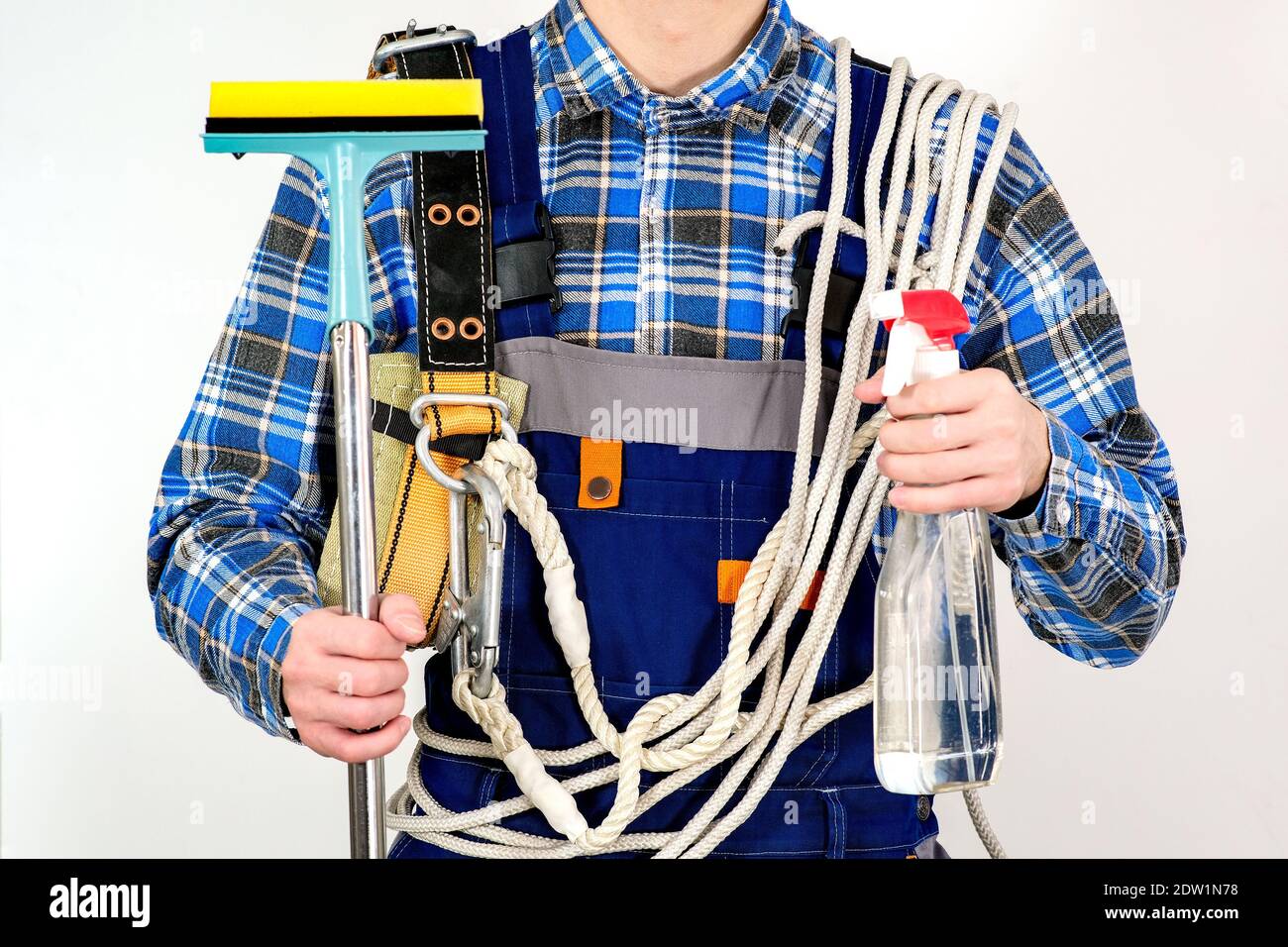 Safety belt on the employee's shoulders. Cleaning supplies in the hands ...