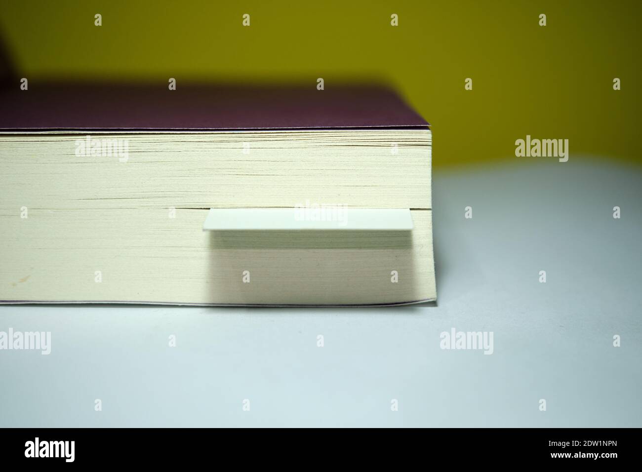 A corner of the thick book and bookmark inside the book. Isolated ...