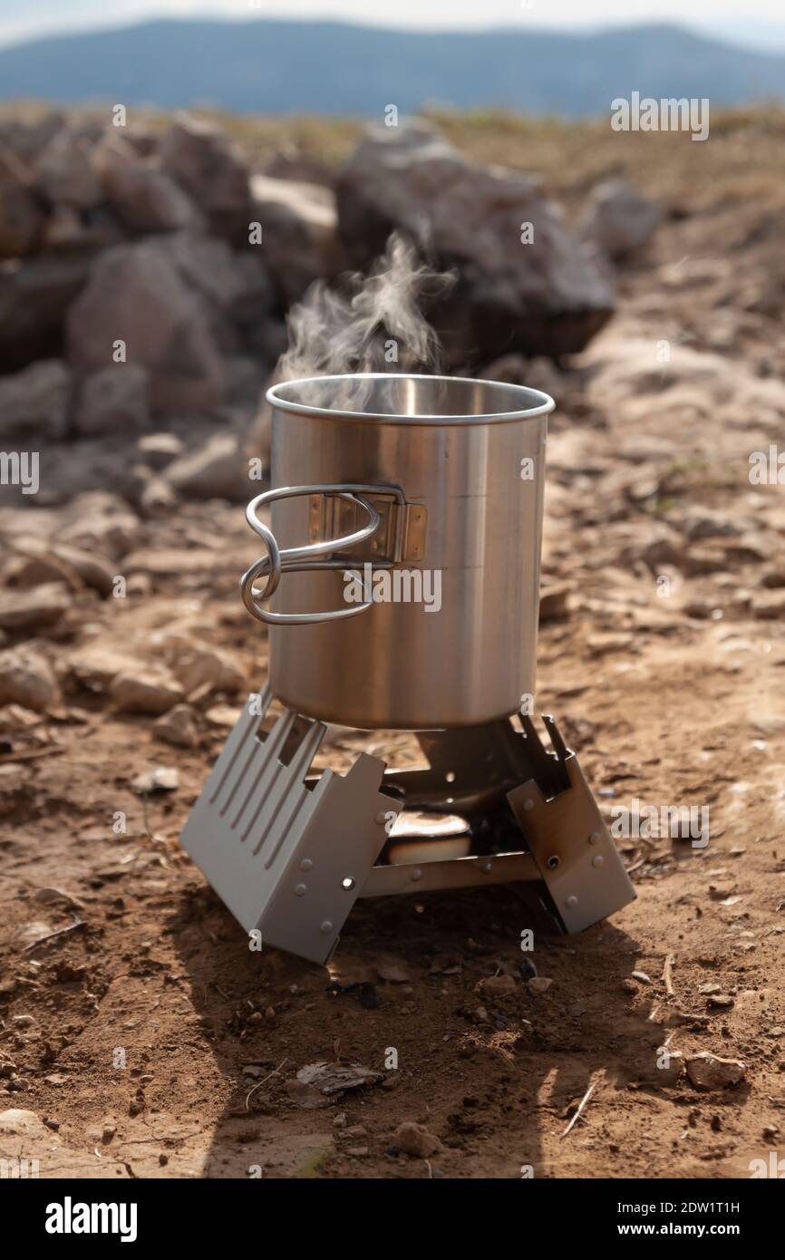 Iron, tourist mugs on an open fire during a camping trip Stock Photo ...