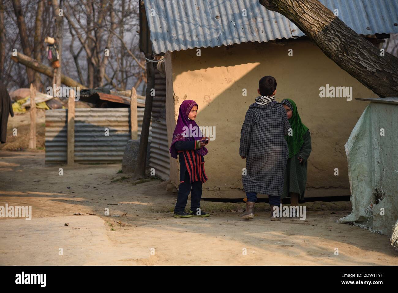 Kashmiri kids playing next to the cave in Tral Pulwama.The ...