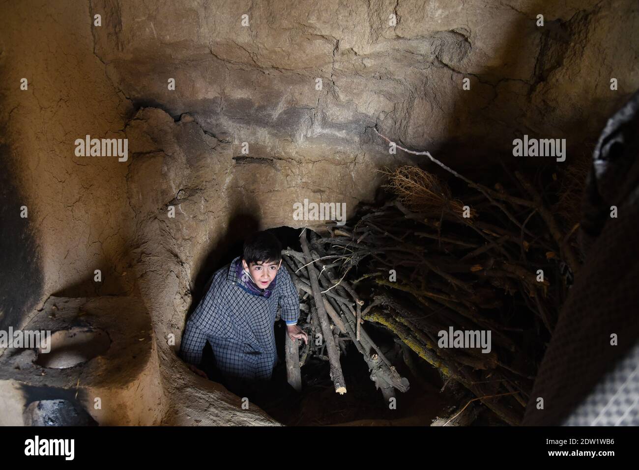 A Kashmiri boy looks on as he enters into the cave in Tral Pulwama.The ...