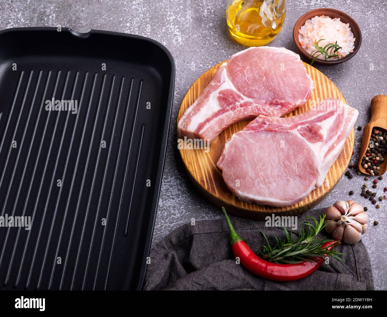 fresh raw meat pork, beef, chop on a bone on the board, spices, grill ...