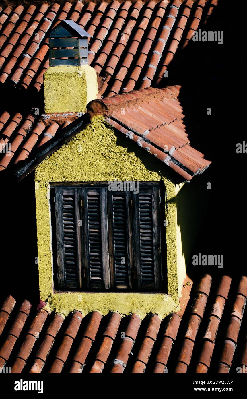 A vertical closeup of a yellow roof dormer Stock Photo - Alamy
