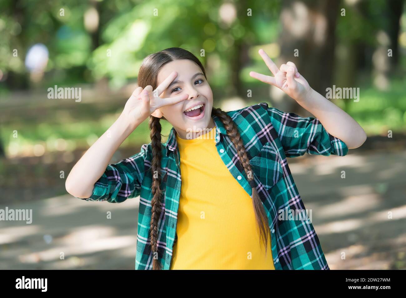 Keeping cool. Cool girl show peace signs natural landscape. Summer ...