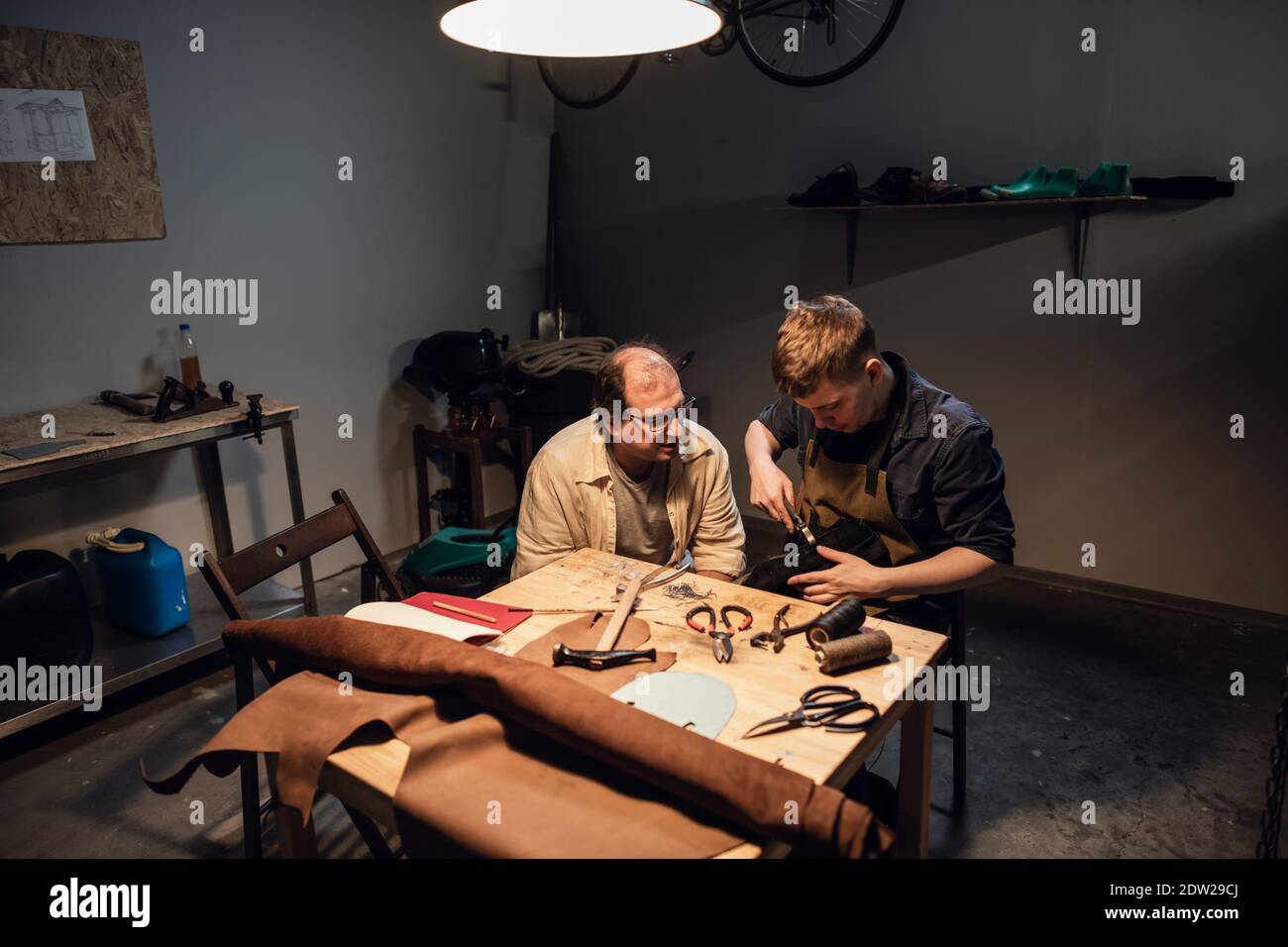 a respectable elderly shoemaker conducts a master class for a young boy ...