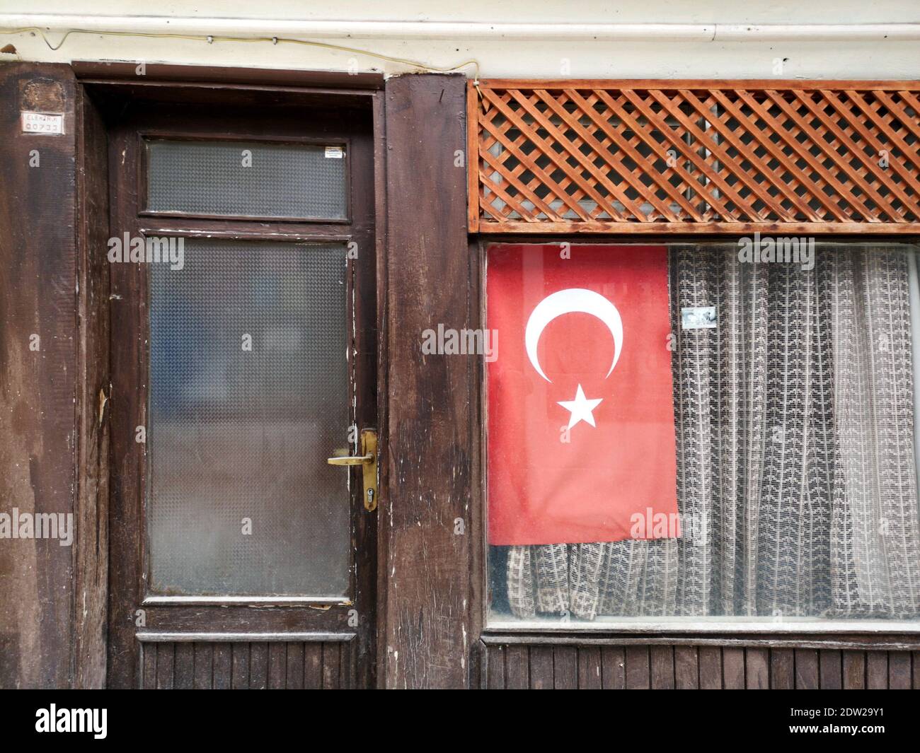 An old wooden house with the flag of Turkey hanging on the window Stock ...