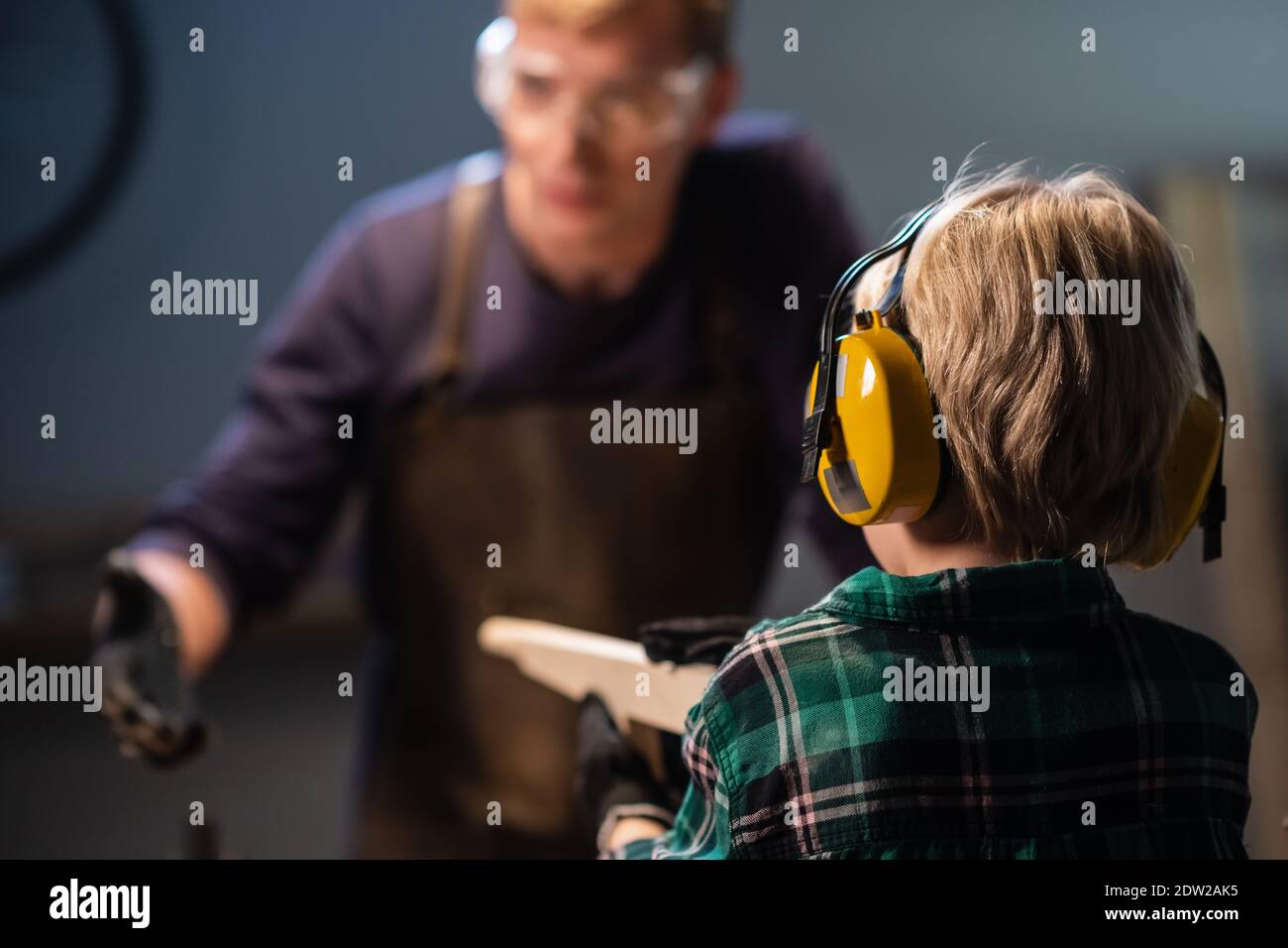 a small boy made a wooden model of a rifle in a carpenter's shop and ...