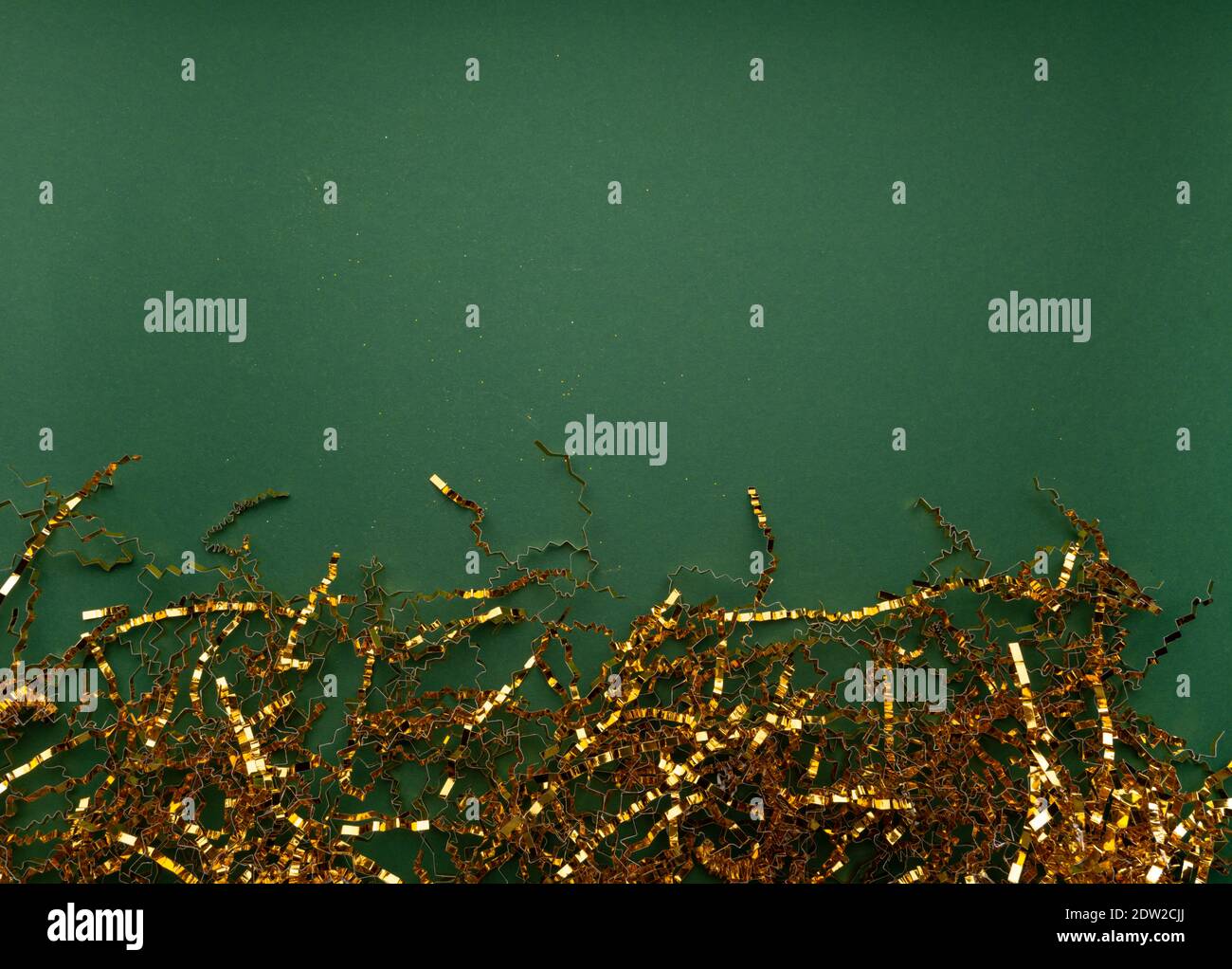 gold metallic festive copper chip paper on green background, template ...