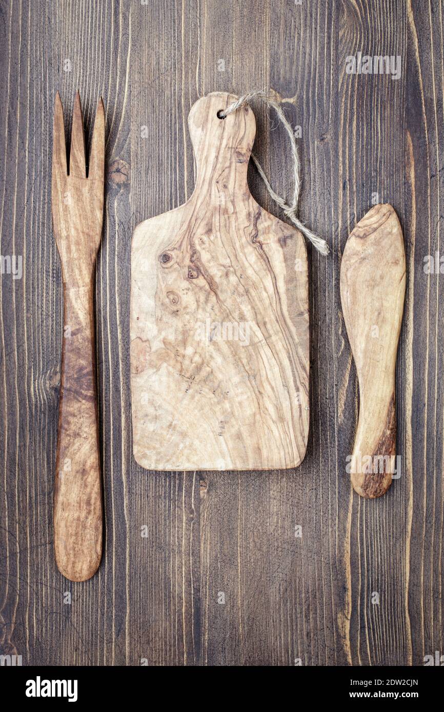 Cutting board, fork and spatula on kitchen table top view Stock Photo ...