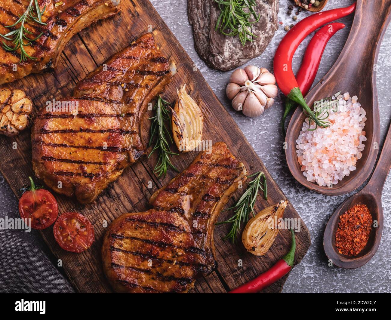 cooked grilled meat pork, beef, chop on a bone, on a cutting board ...