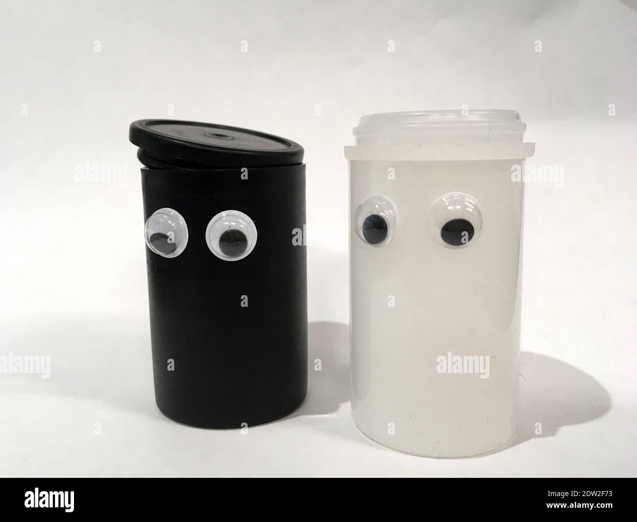 Close-up Of Containers With Googly Eyes Over White Background Stock ...