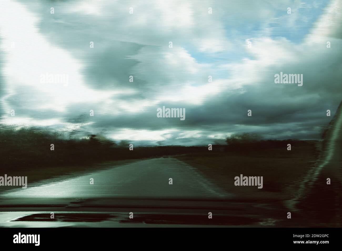 Unfocused blurred view through the moving car windscreen inside the car ...