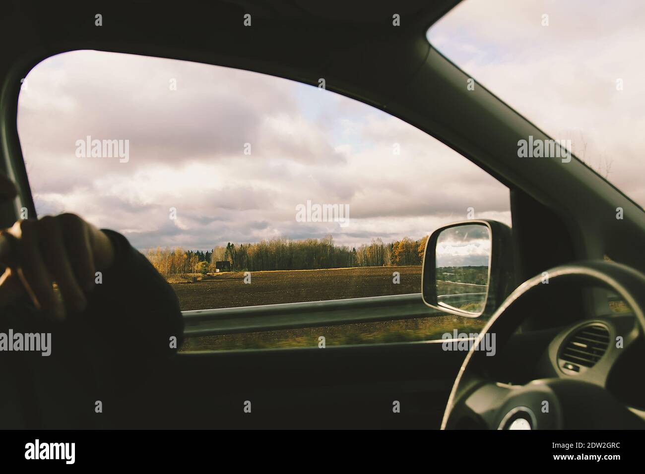 View through the moving car windscreen inside the car interior. Man ...