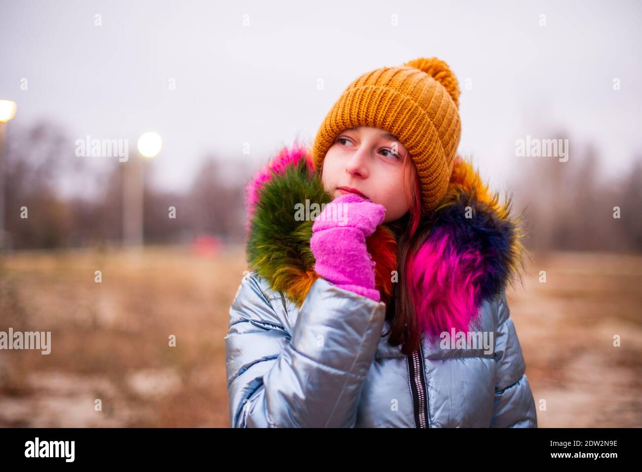 Young beautiful woman wearing winter clothing. Teenage girl in a jacket ...