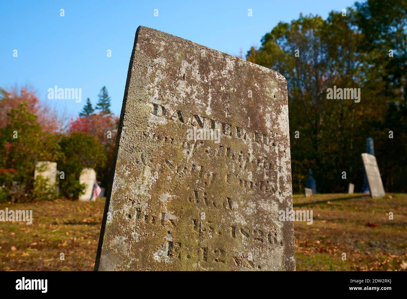 A plain, old slab stone grave, covered in moss and lichen. At the Bay ...