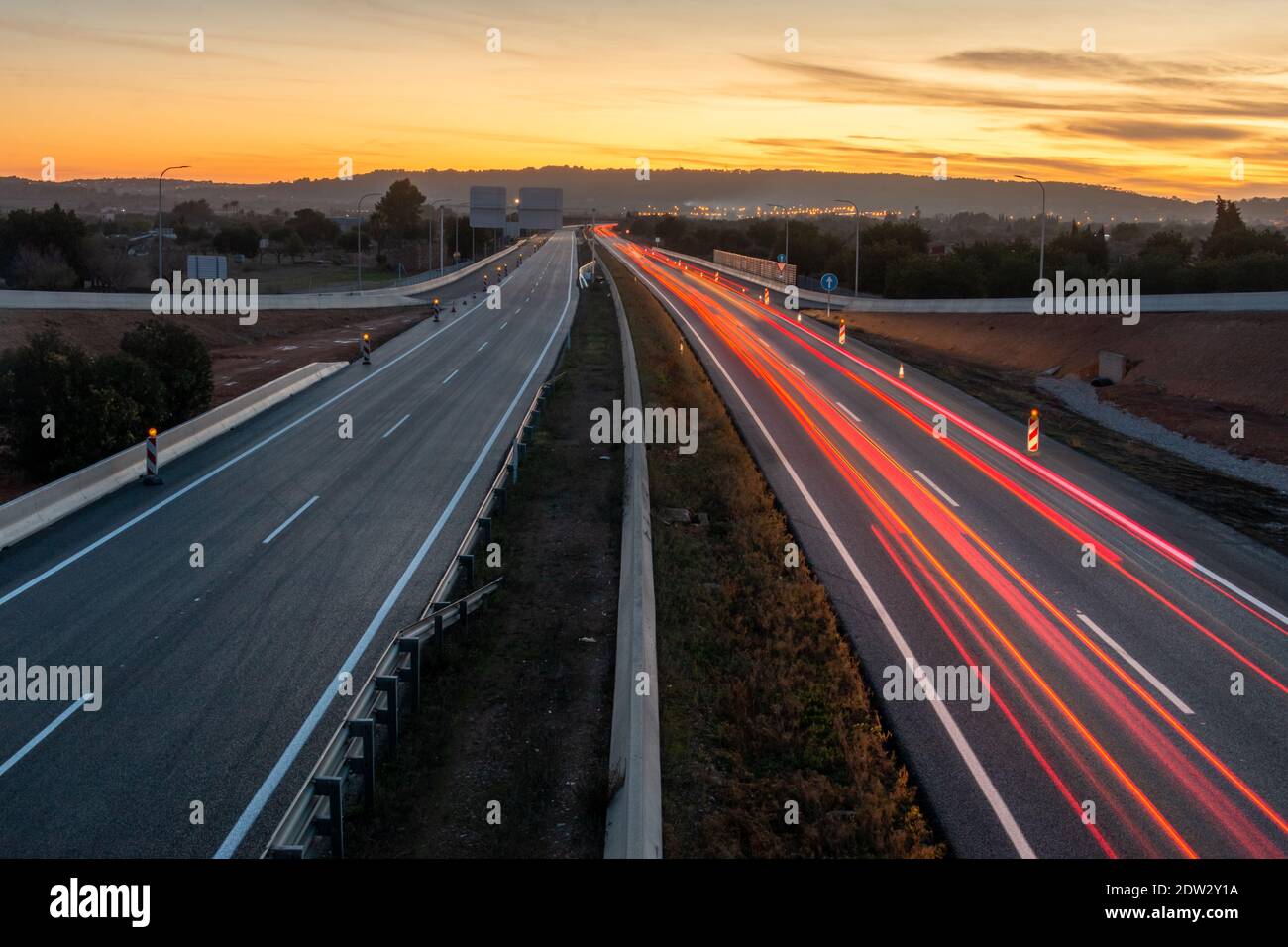 On a highway, red light trails of the cars only in one direction and ...
