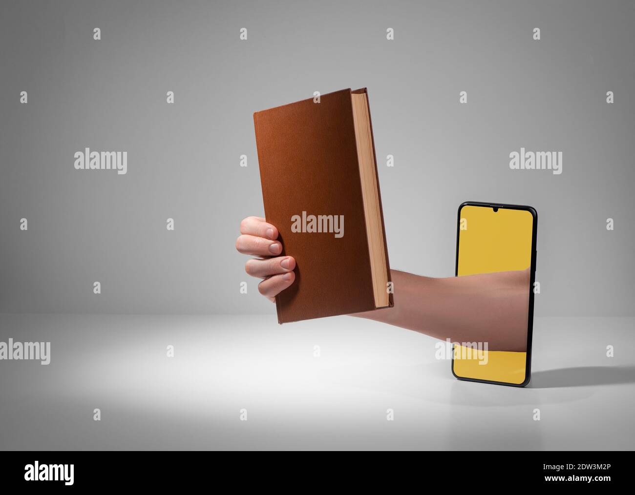 Hand giving a book from out of a phone screen Stock Photo - Alamy