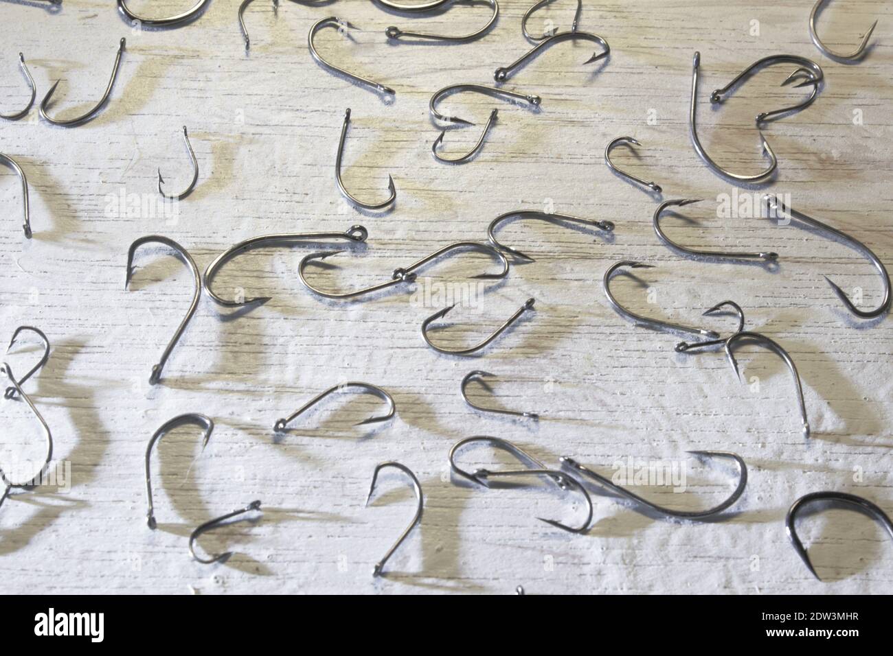 picture on white background full of fishing hooks Stock Photo - Alamy