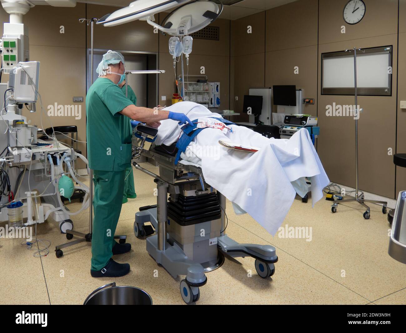 in an operating room, a ventilated patient is monitored by the ...
