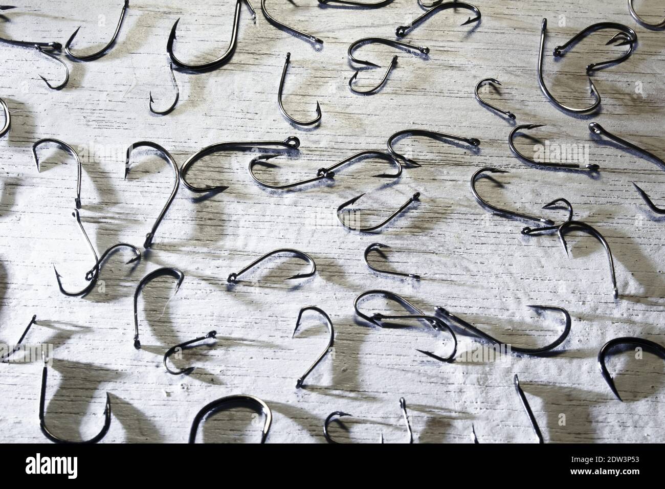 picture on white background full of fishing hooks Stock Photo - Alamy
