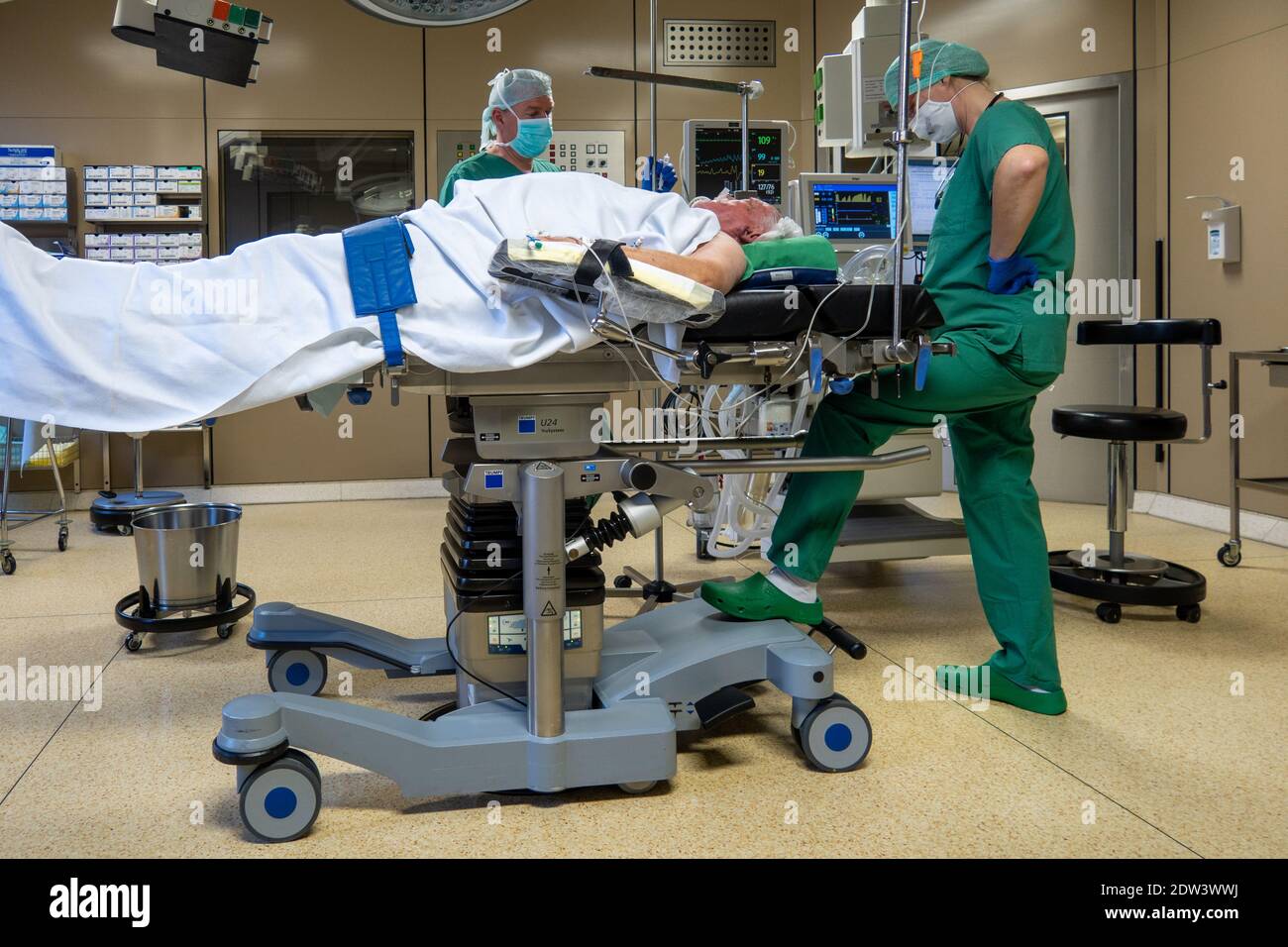 in an operating room, a ventilated patient is monitored by the ...