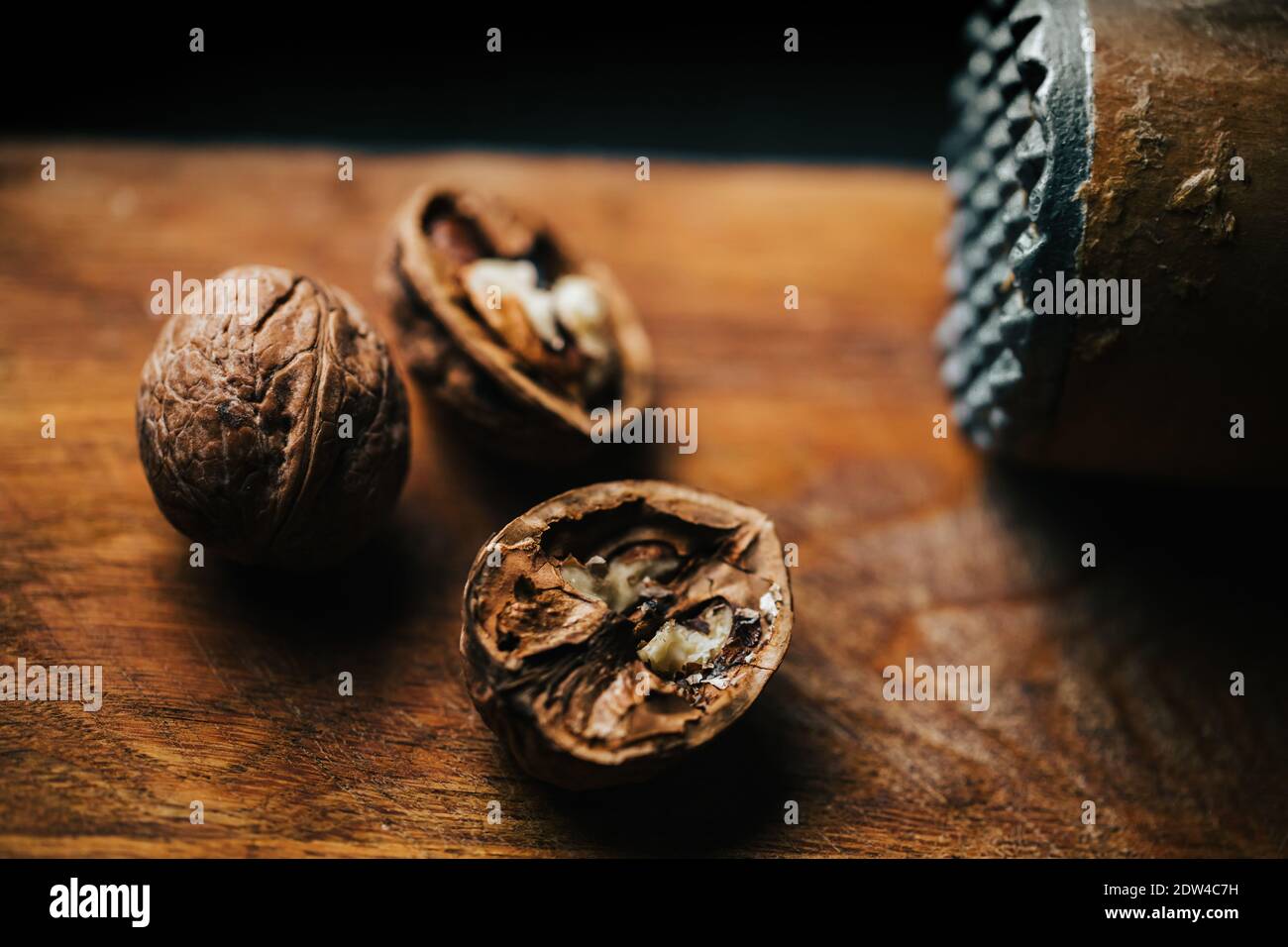 A top view of the walnut breaking process with a wooden mallet Stock ...