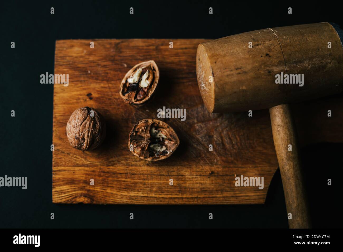 A top view of the walnut breaking process with a wooden mallet Stock ...