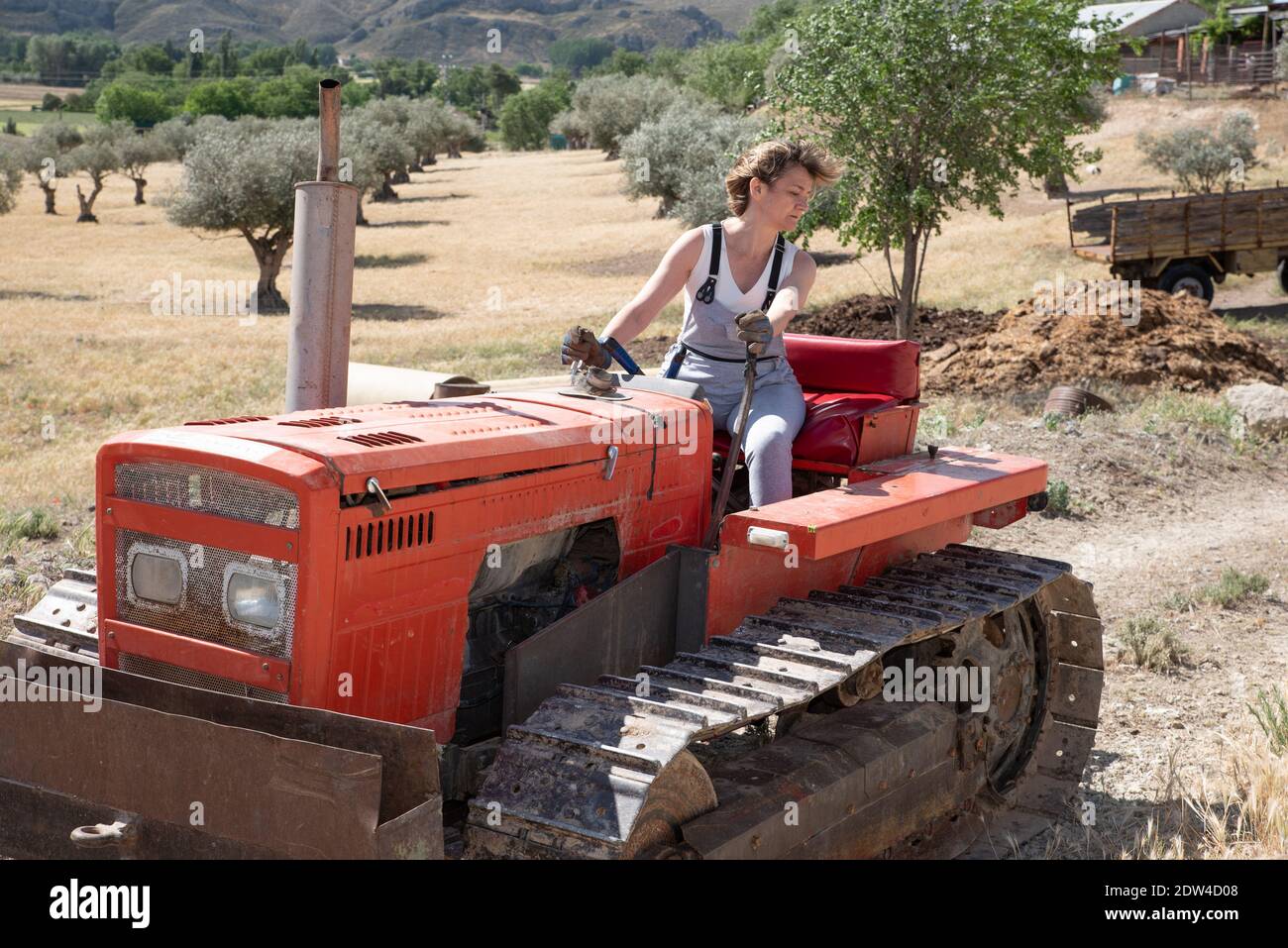 Woman farmer driving a tractor Stock Photo - Alamy