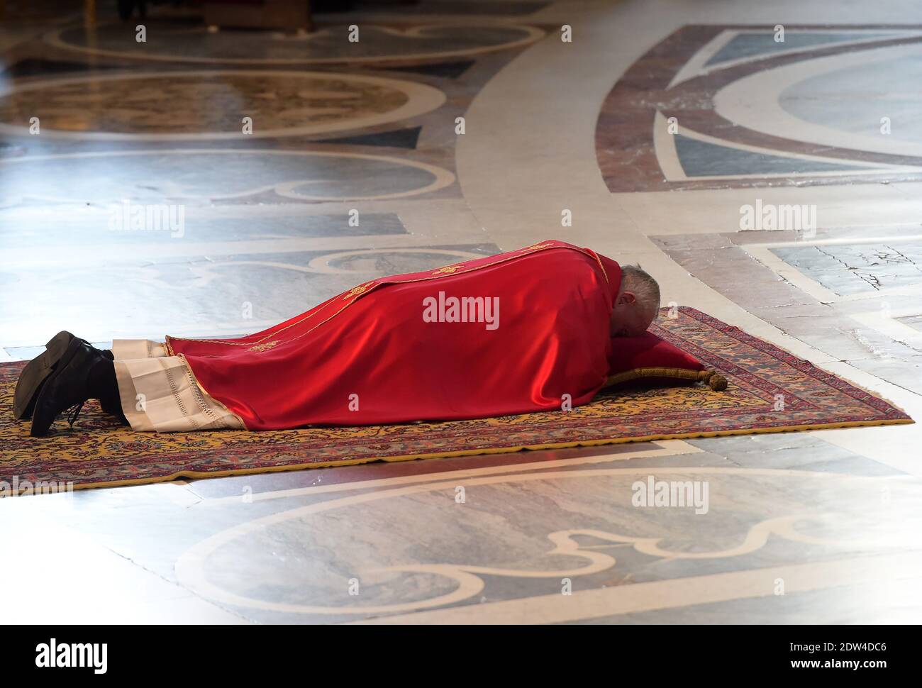 Pope Francis lies down in prayer during the Passion of Christ Mass on ...