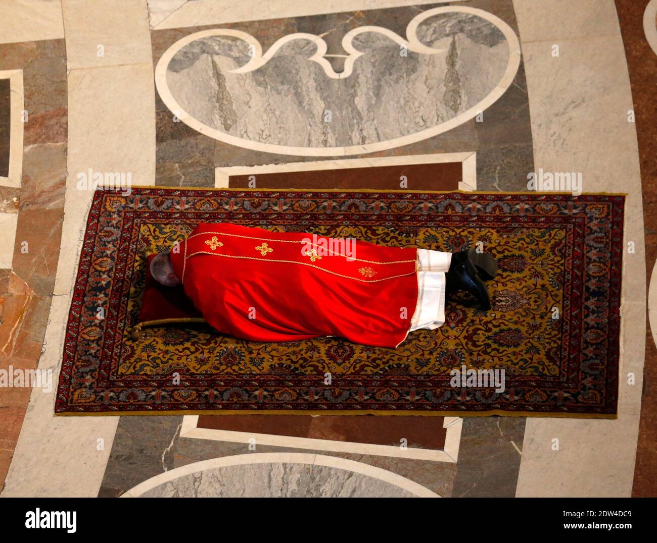 Pope Francis lies down in prayer during the Passion of Christ Mass on ...