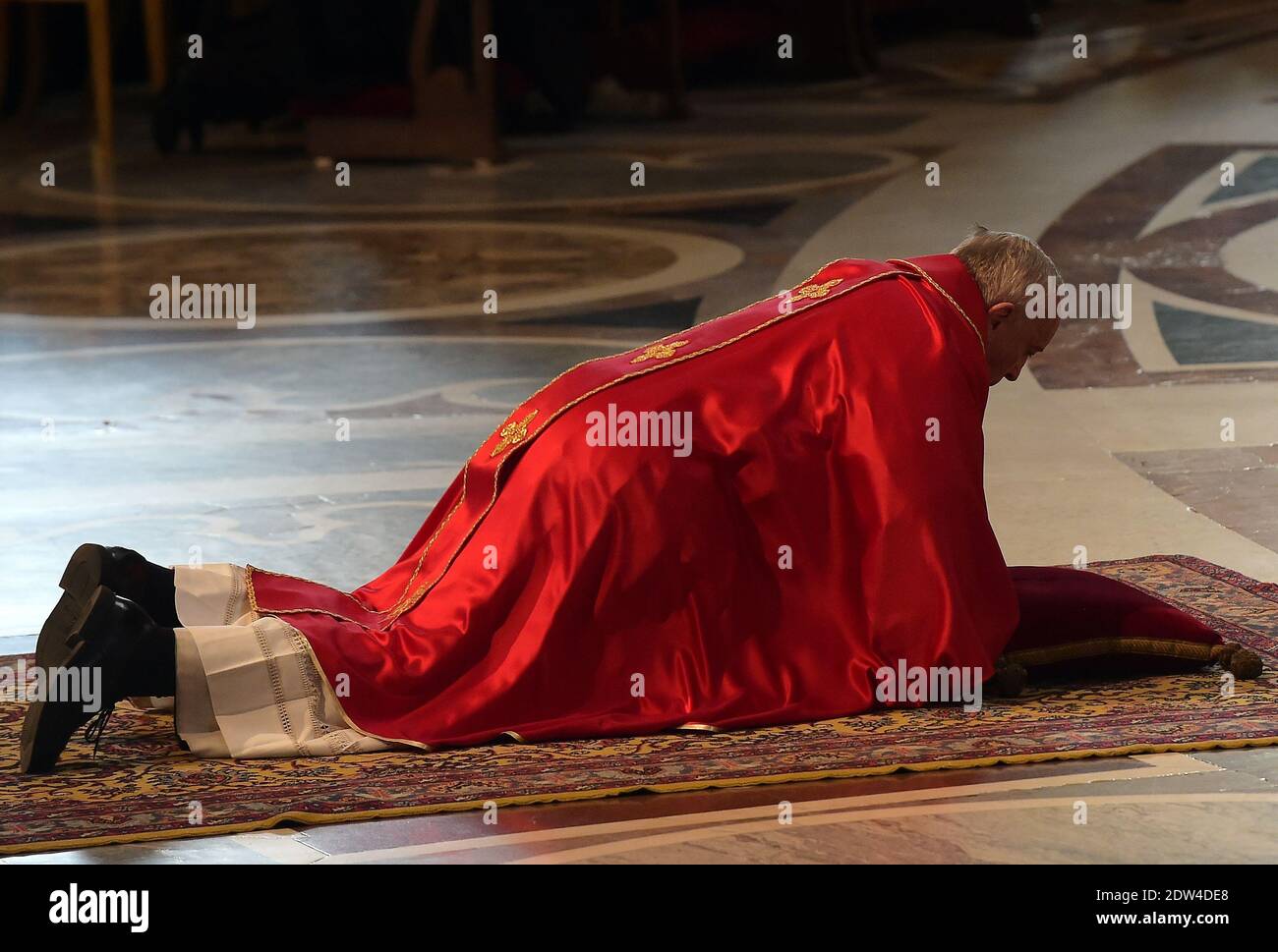 Pope Francis lies down in prayer during the Passion of Christ Mass on ...