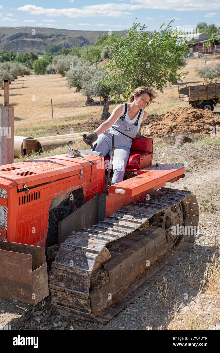 Woman farmer driving a tractor Stock Photo - Alamy