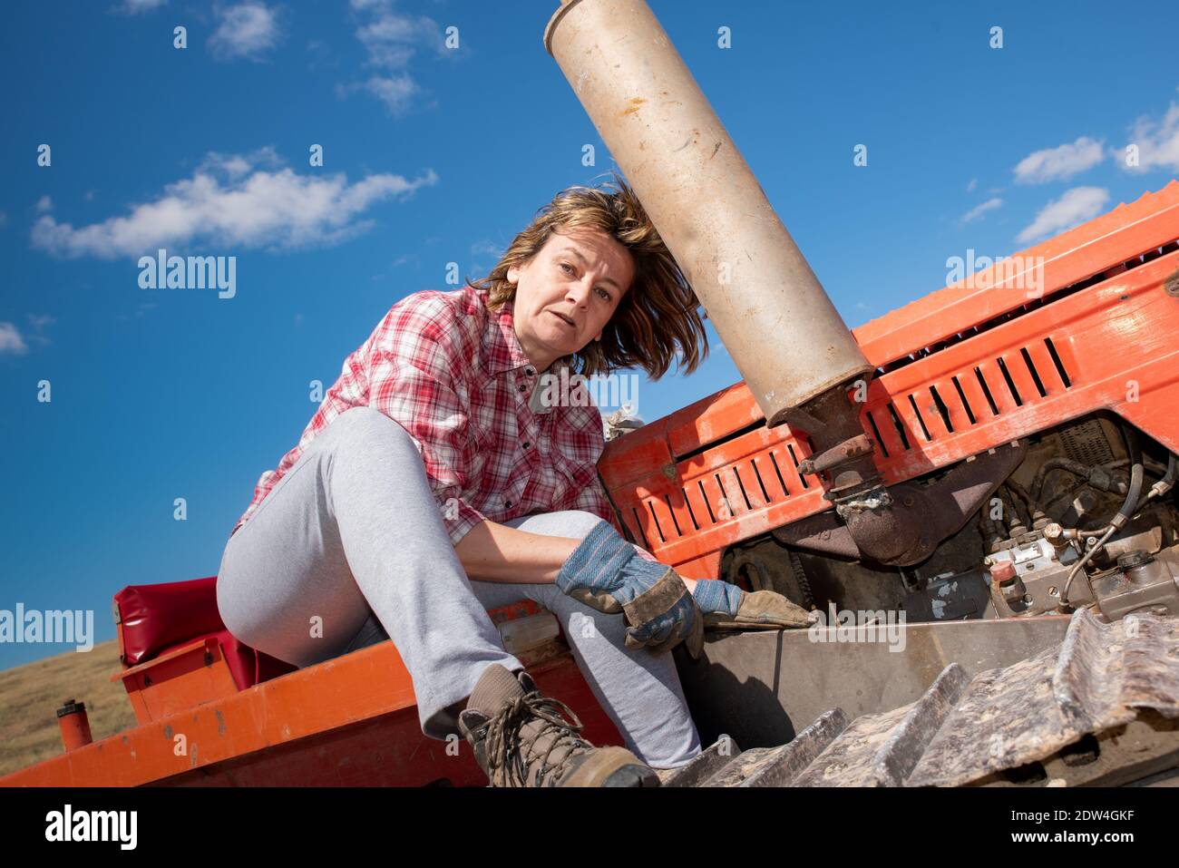 Woman farmer repairing a tractor Stock Photo - Alamy