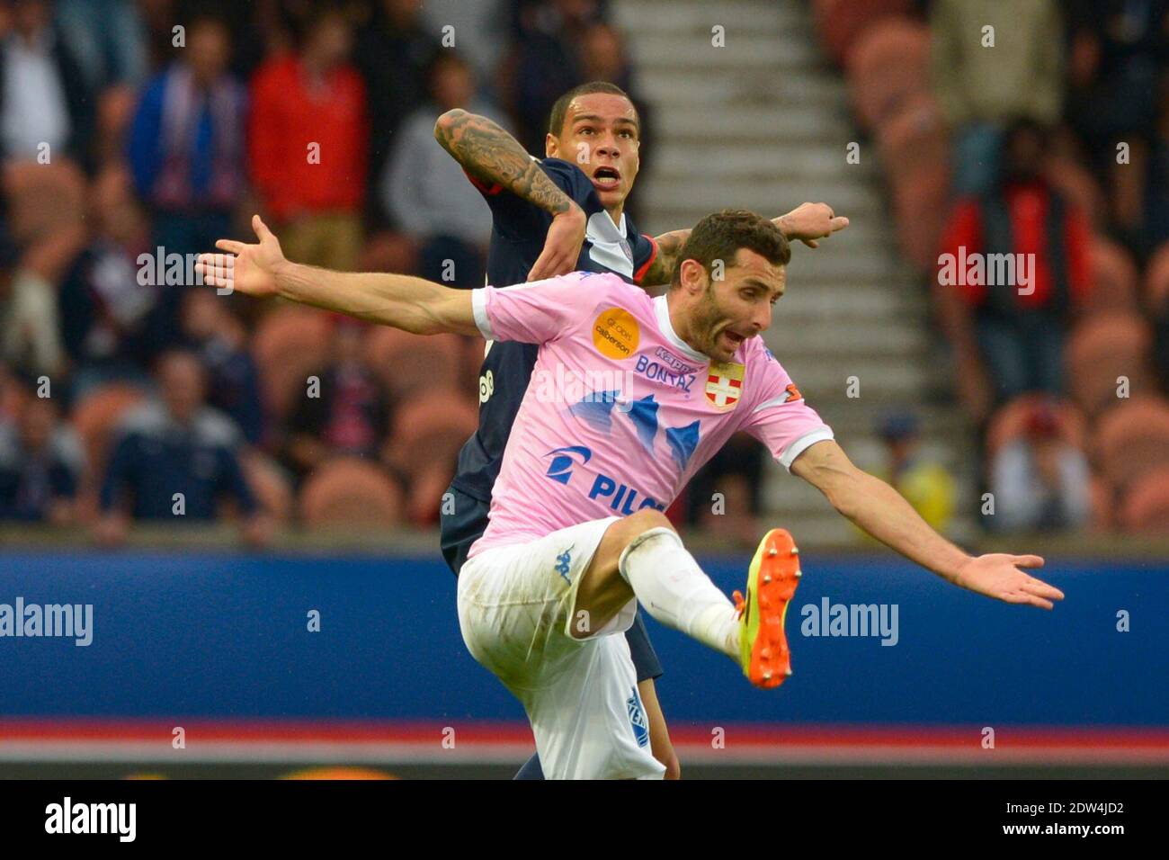 PSG's Gregory Van der Wiel battling Evian's Cedric Barbosa during the French First League soccer ...