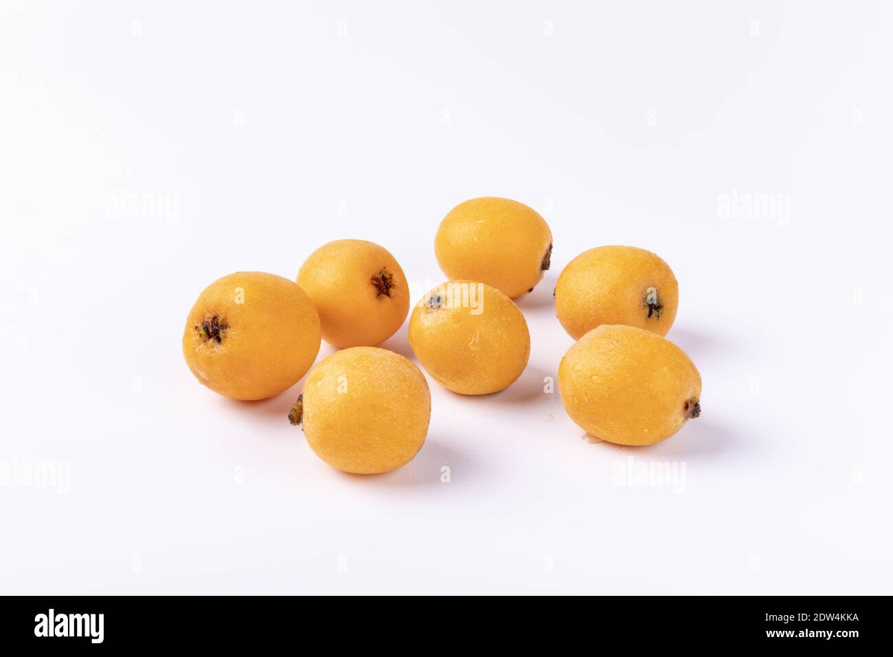 Fresh loquat fruits isolated on a white background Stock Photo - Alamy
