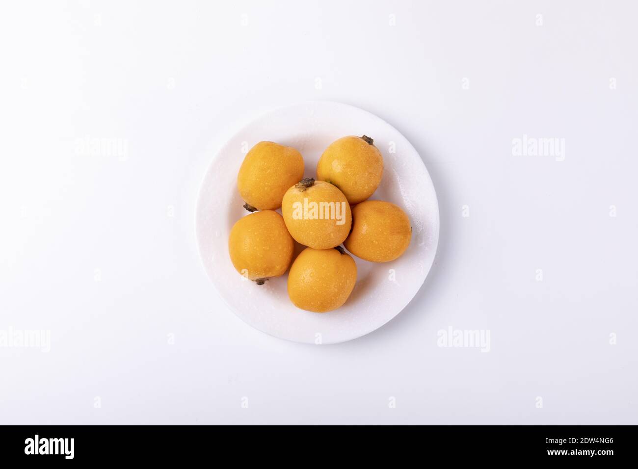 Fresh loquat fruits isolated on a white background Stock Photo - Alamy