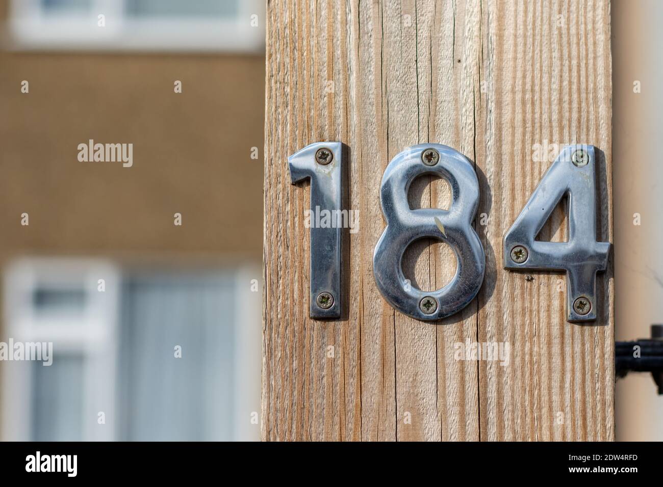 SIlver metal digits on light wood form hoie number 184 Stock Photo - Alamy