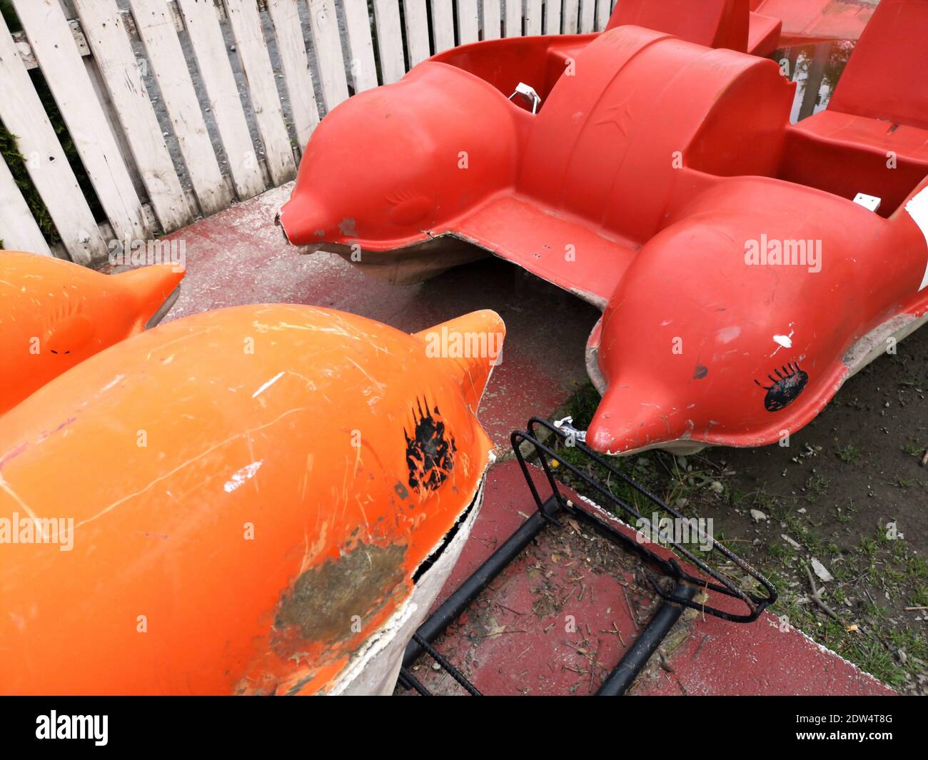 A shot of an abandoned red and orange carousel seats outdoors Stock ...