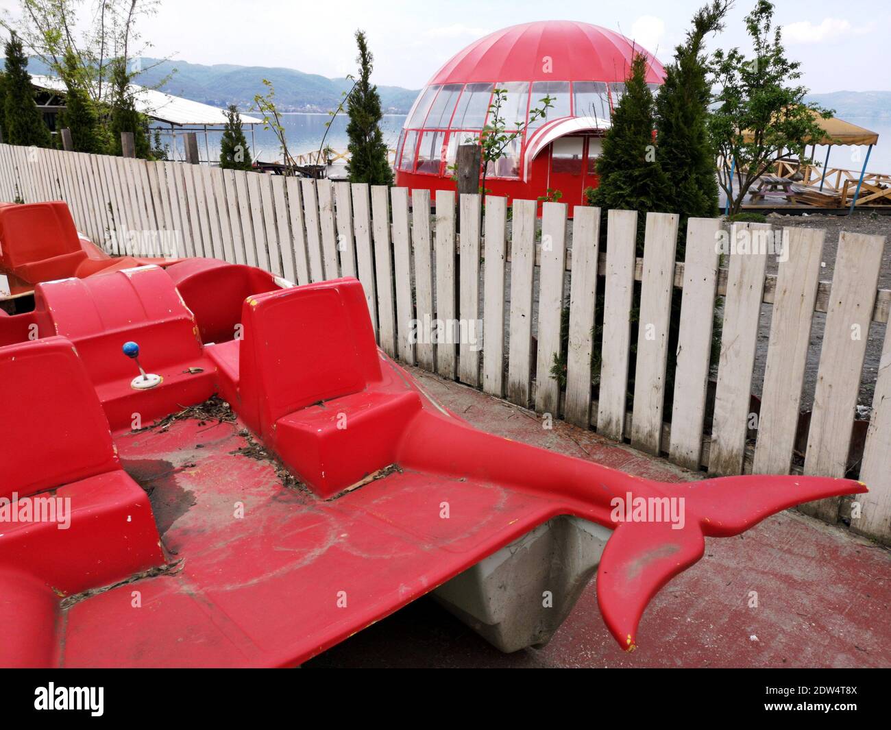 A vertical shot of an abandoned red carousel seats outdoors Stock Photo ...