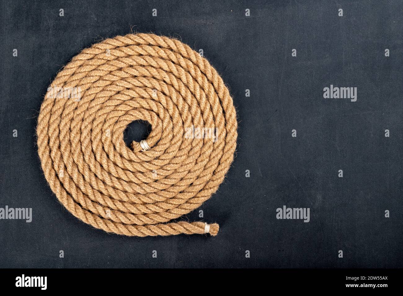 Thick jute rope coiled in the shape of a circle. Sailing accessories ...
